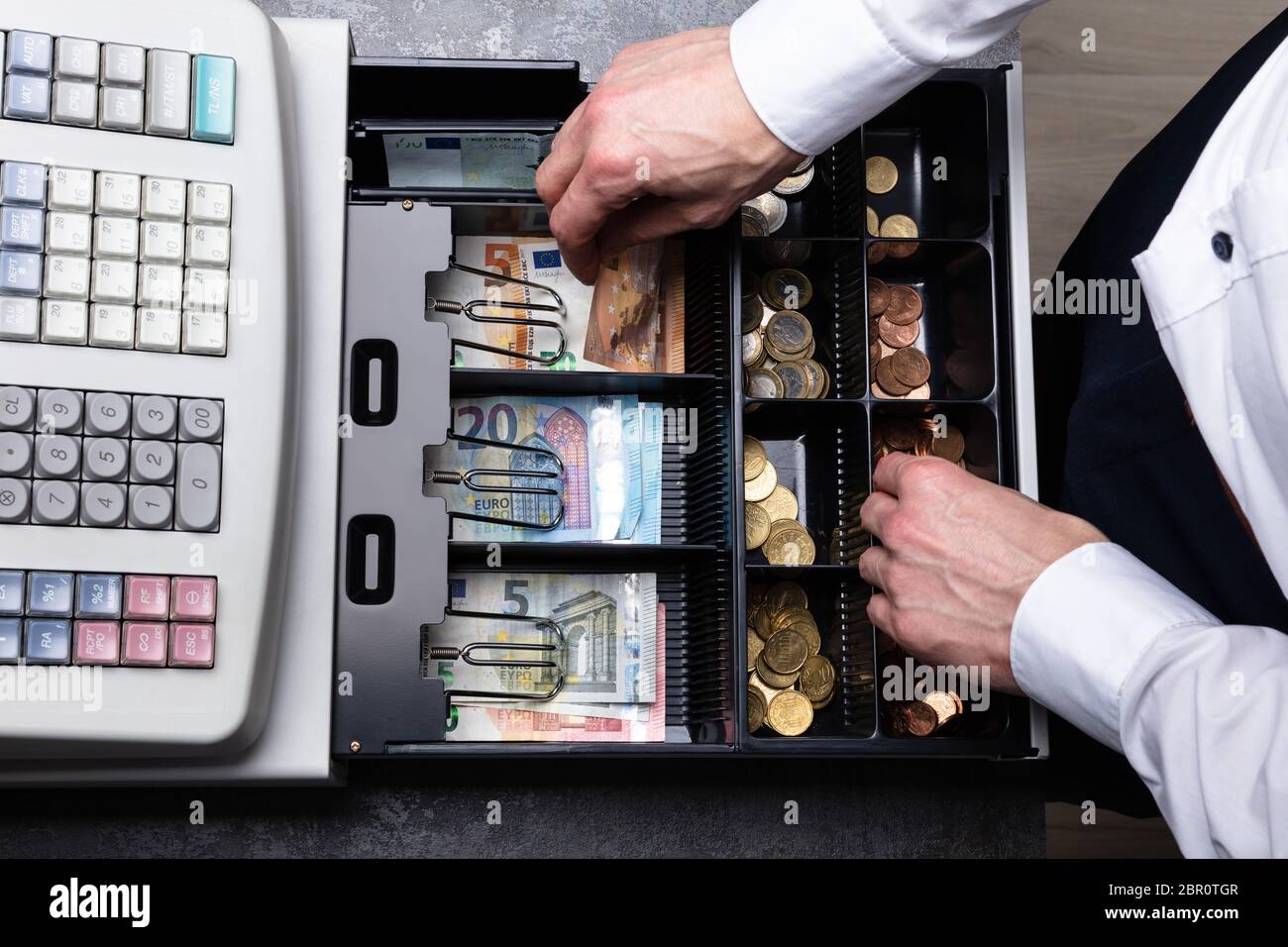 An Overhead View Of Cashier's Hand Taking Banknote From Opened Till ...