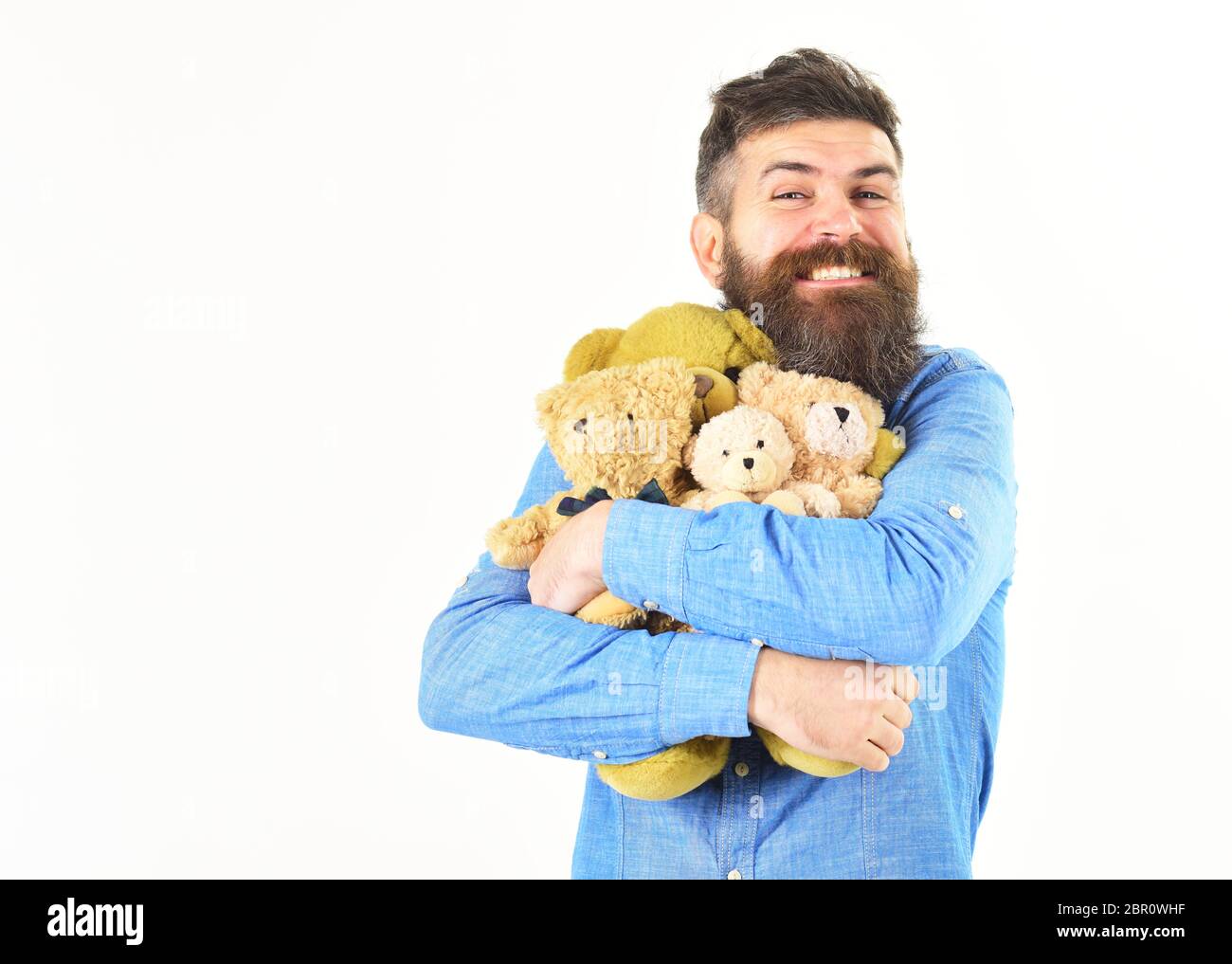 Bearded man hugs many teddy bears. Teddy bears and toys concept Stock ...