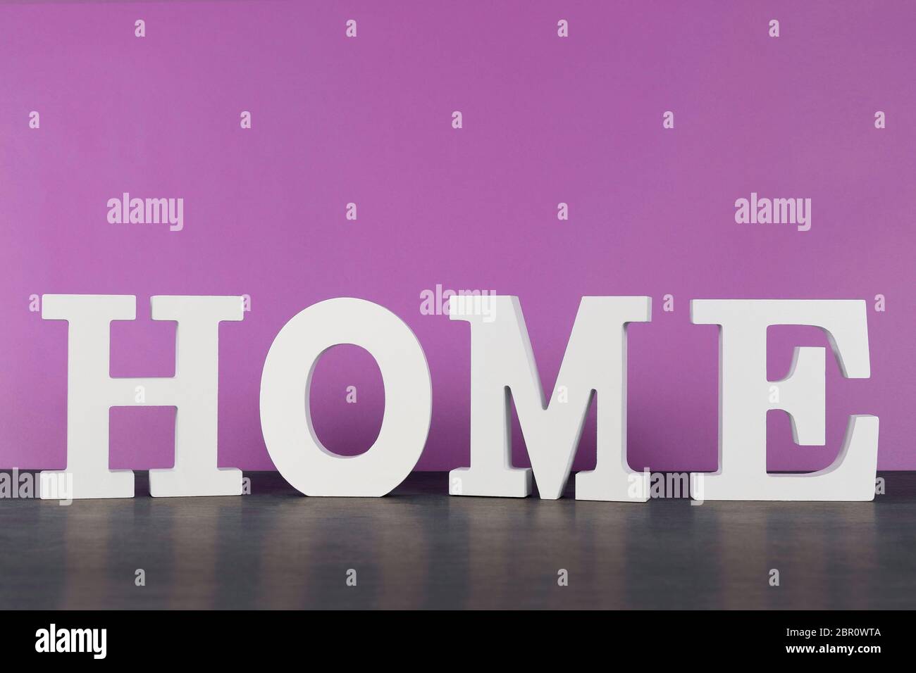 Home, written in letters, with pink wall paint Stock Photo - Alamy