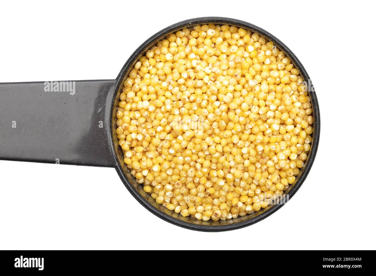Raw millet in measuring spoon on white background Stock Photo - Alamy