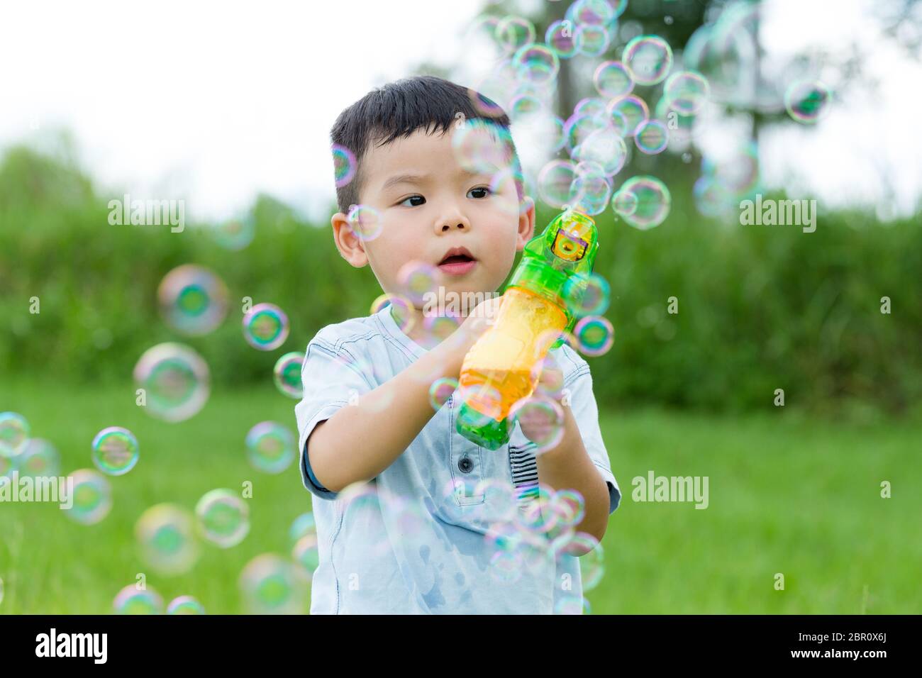 Little boy play with bubble blower at outdoor Stock Photo - Alamy