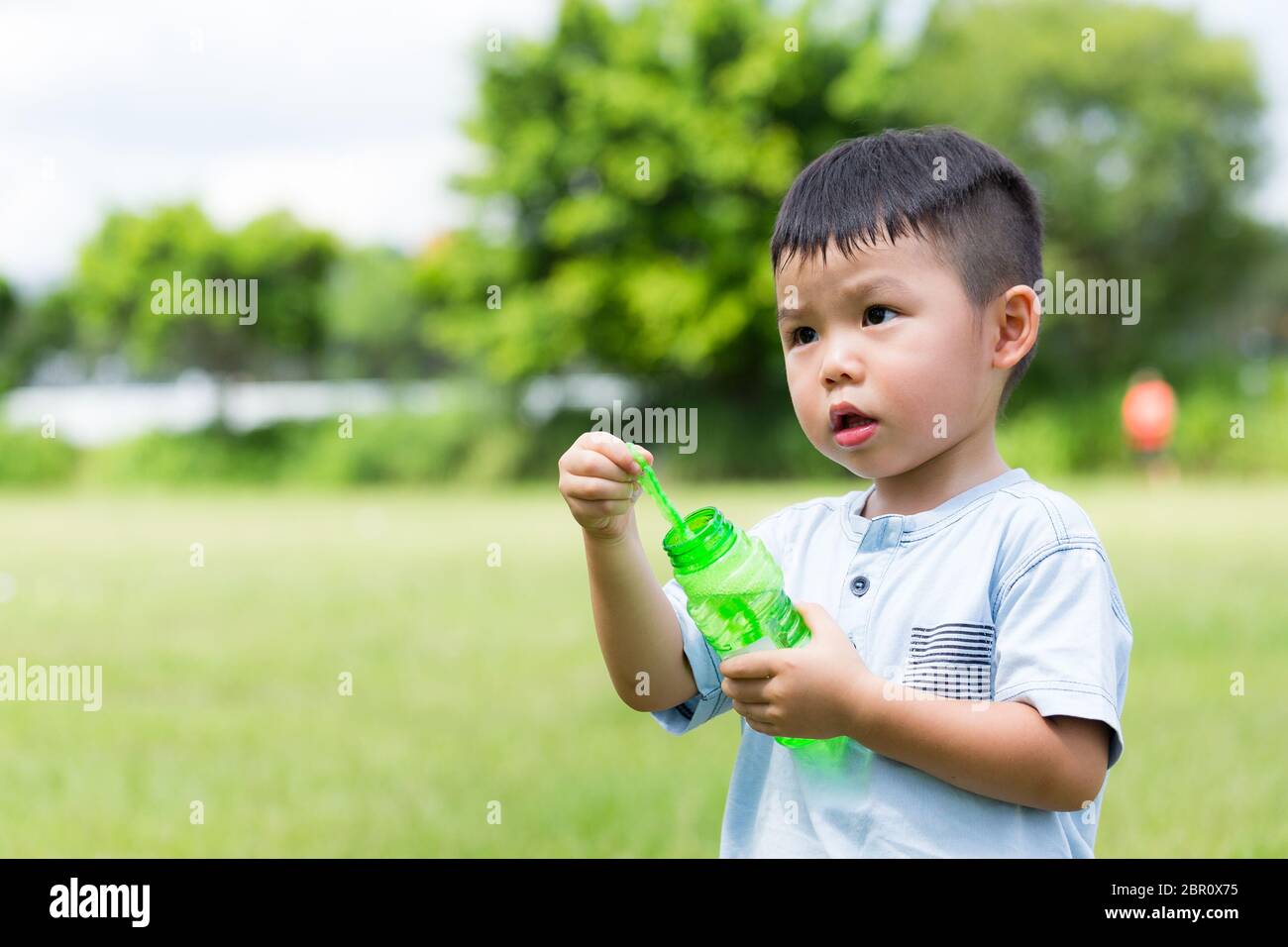 Little boy play with bubble blower Stock Photo - Alamy