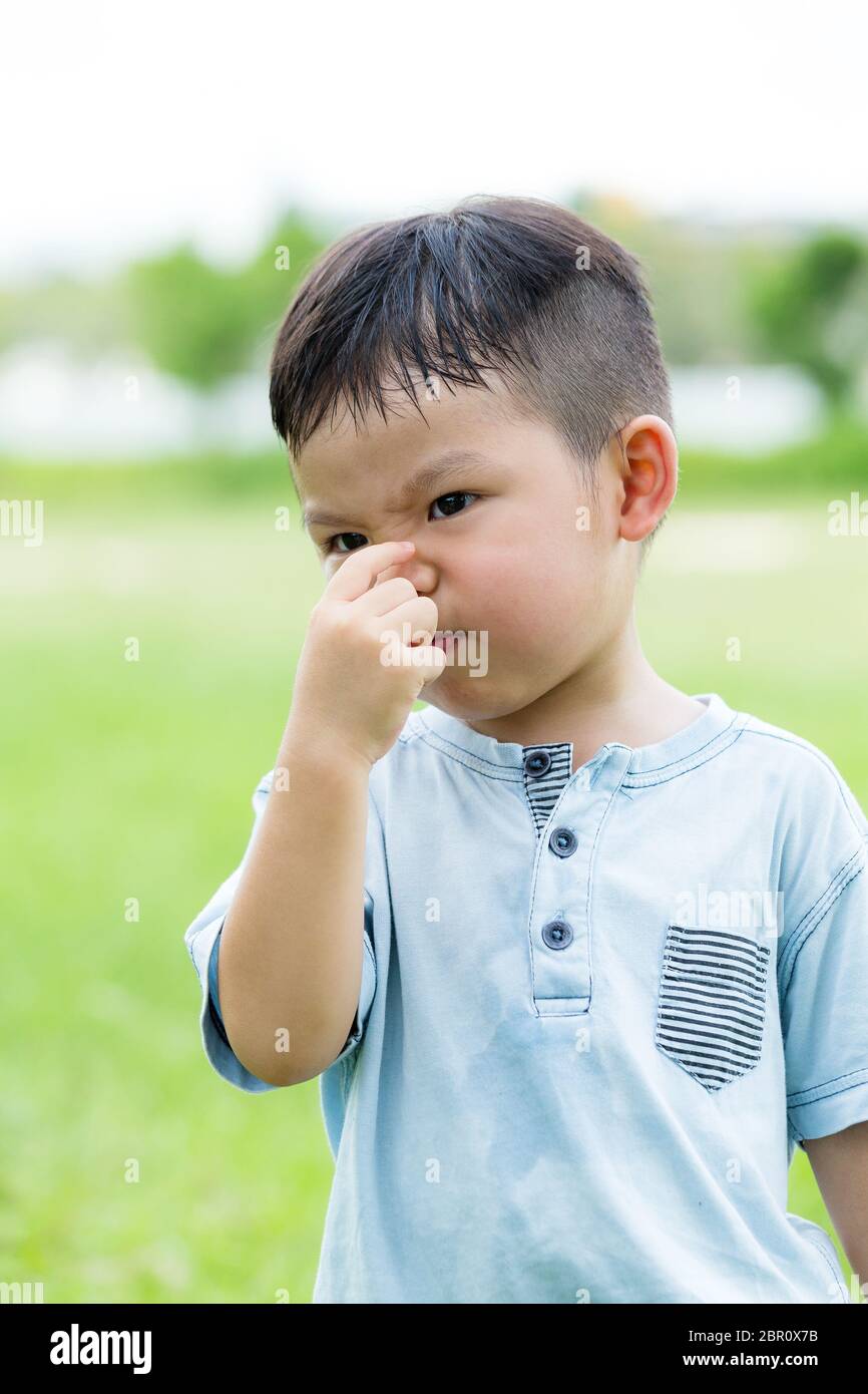 Little boy with hand pinch on his nose Stock Photo - Alamy