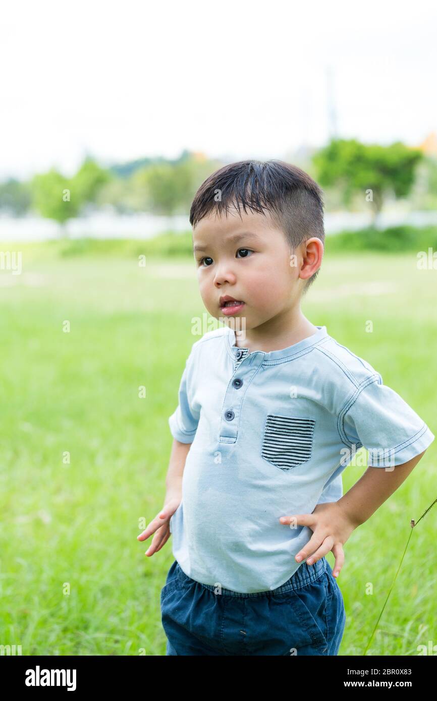 Little boy taking rest after play at outdoor Stock Photo - Alamy