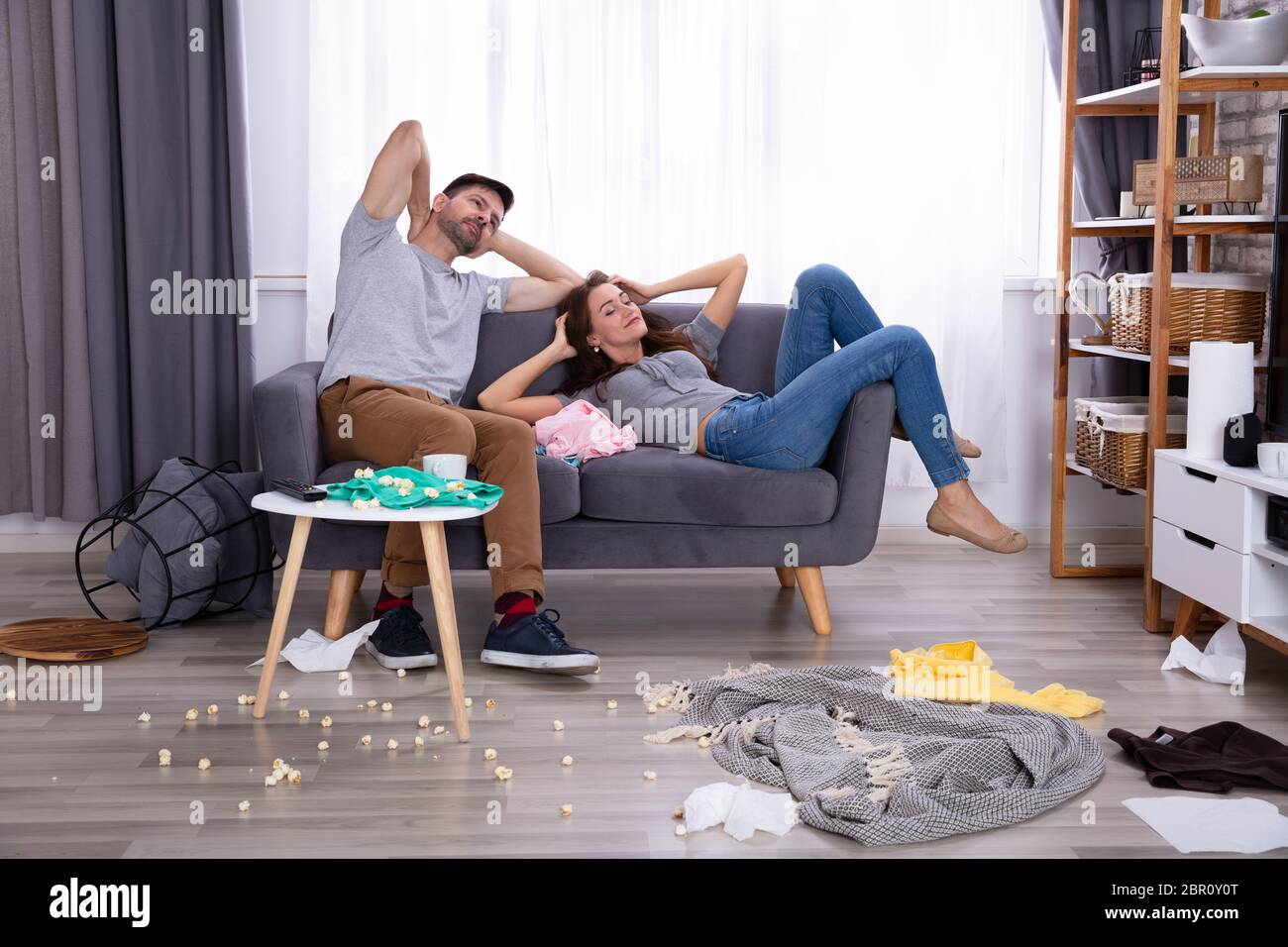 Woman in messy living room hi-res stock photography and images - Alamy