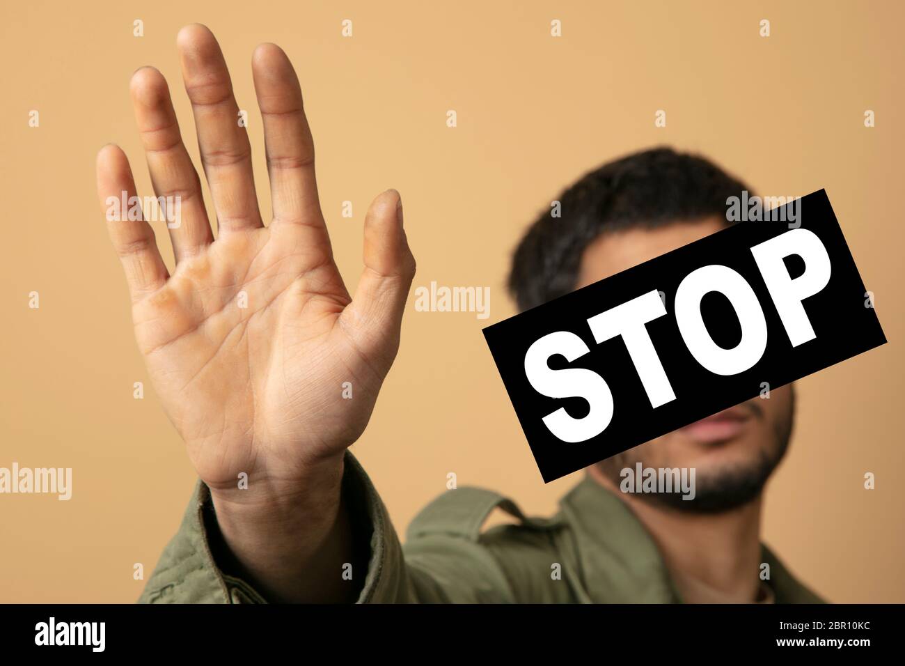 Young Man shows STOP Sign with his hand Stock Photo - Alamy
