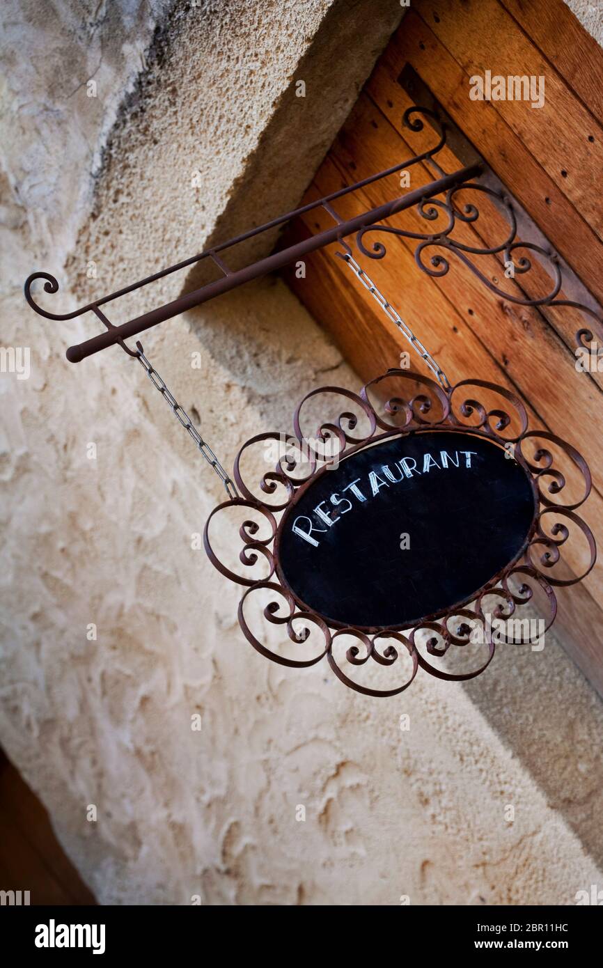 Wrought iron restaurant sign in a French village Stock Photo - Alamy