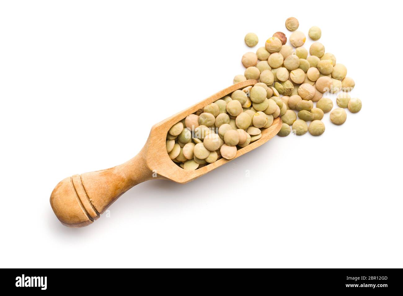 Uncooked dried lentil in wooden scoop isolated on white background ...