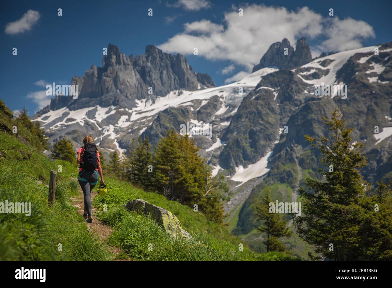 Pretty, female hiker/climber in a lovely alpine setting of Swiss Alps ...