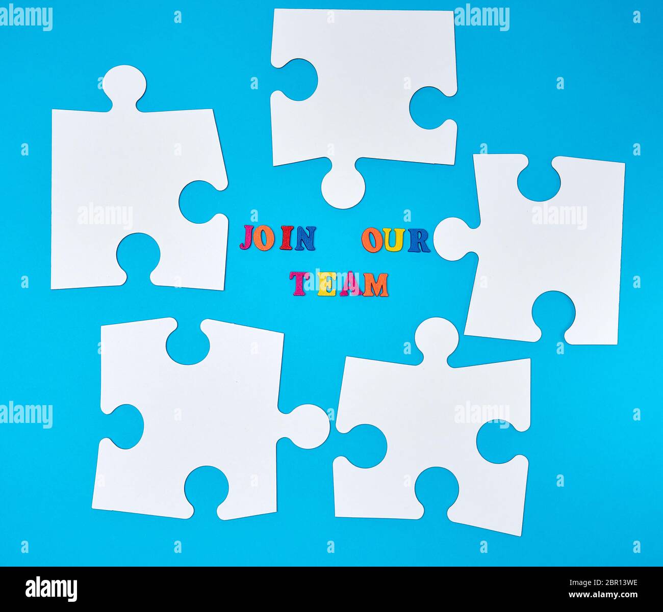 paper blank white puzzle on a blue background, the inscription join our ...