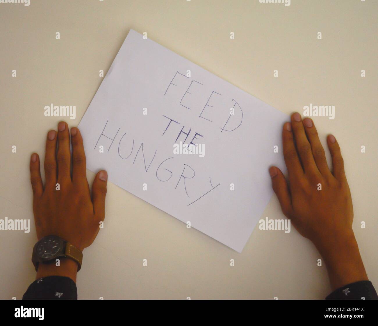 hands holding a paper, feed the hungry concept Stock Photo - Alamy
