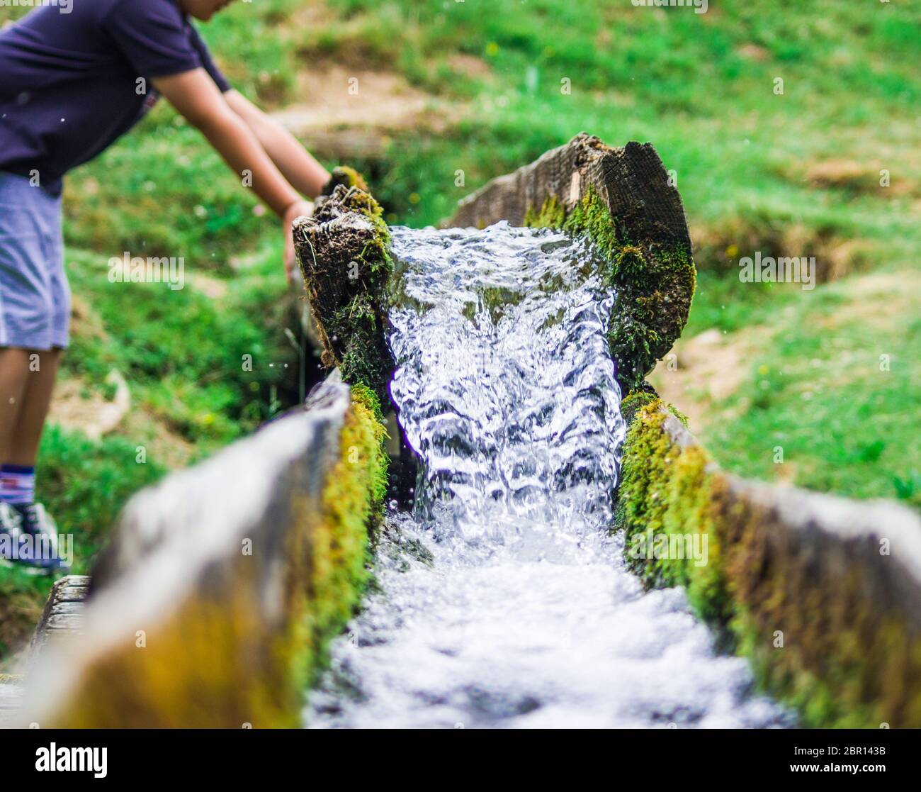 fresh and clean spring water flows down the mountain towards the valley ...