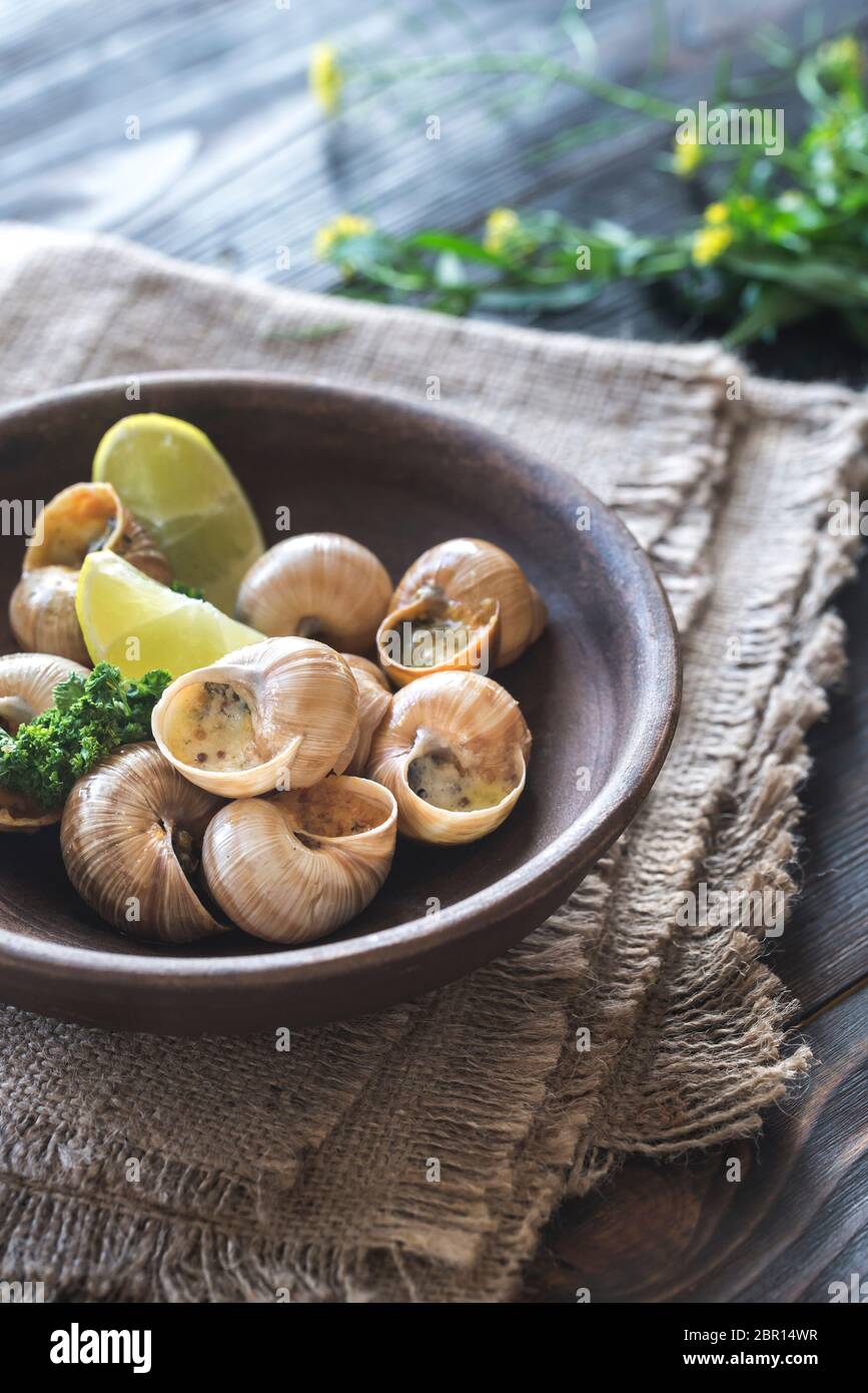 Bowl of cooked snails Stock Photo - Alamy