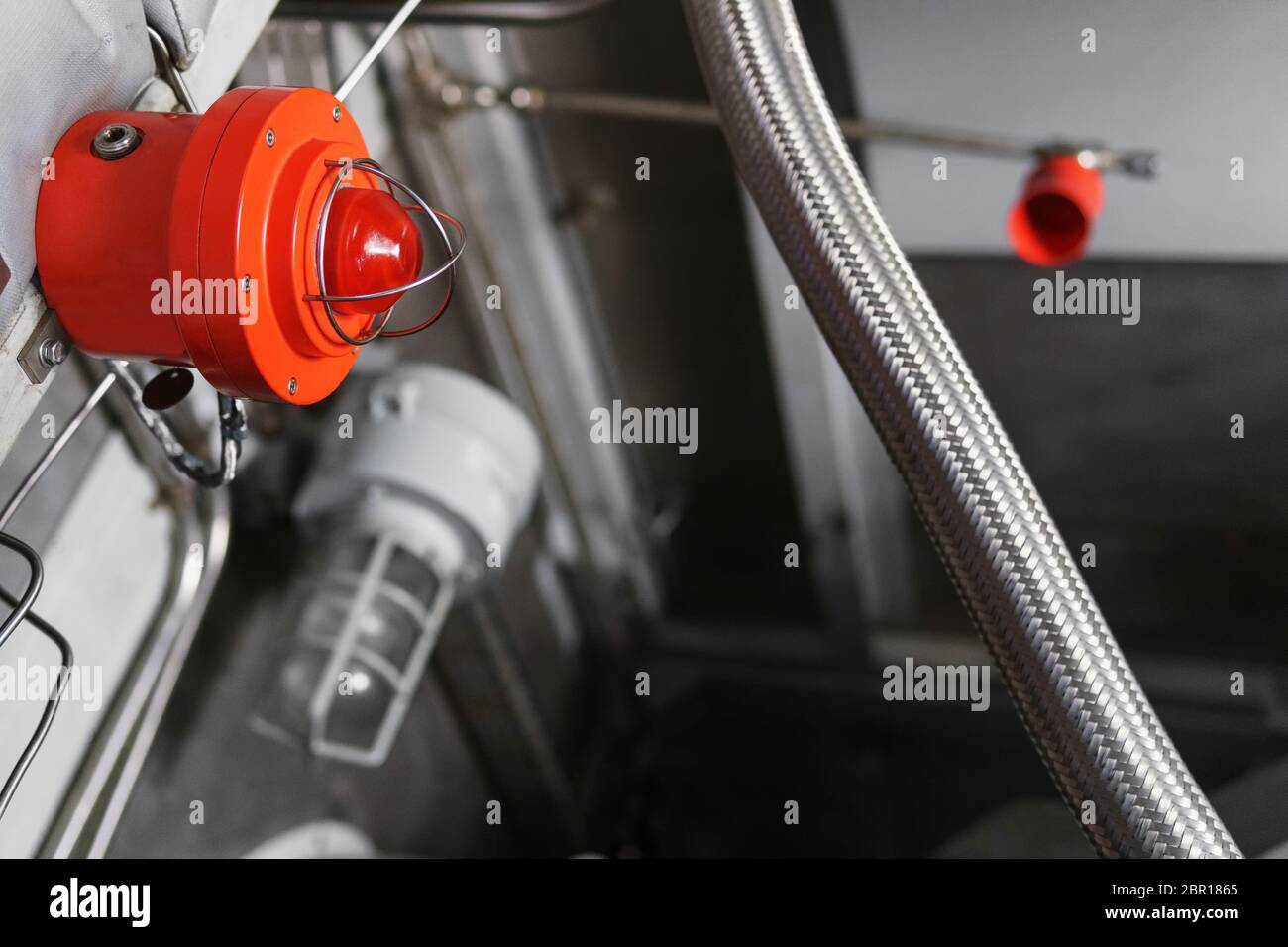 Red warning light of an emergency beacon at an industrial facility. A ...