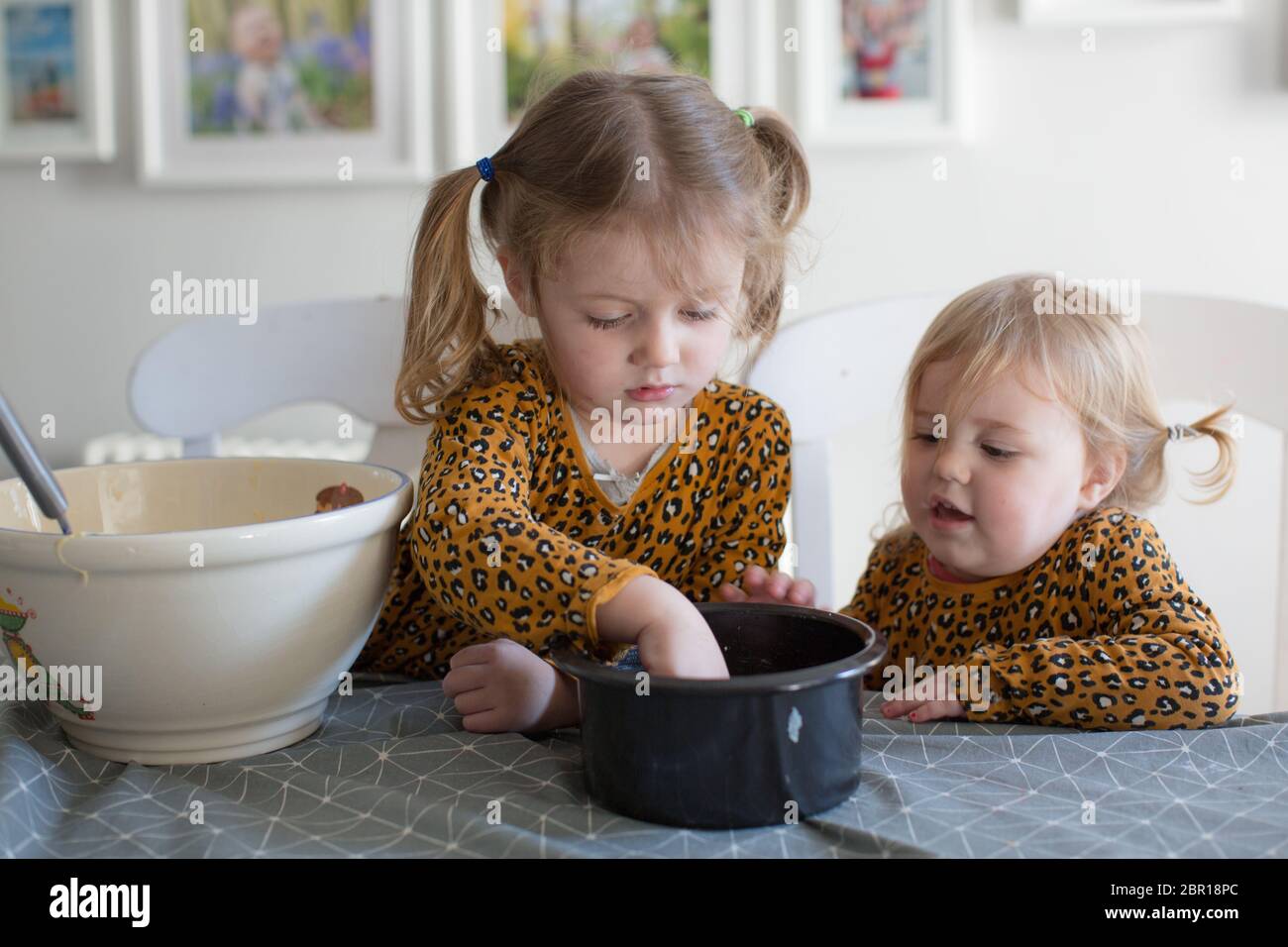 Child cooking cake licking spoon hi-res stock photography and images ...