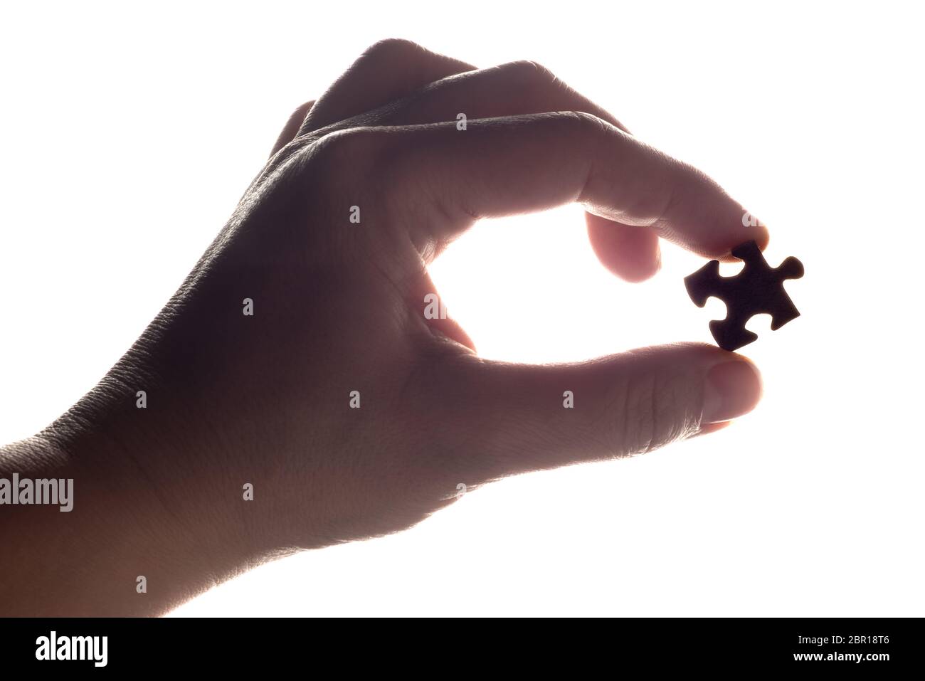 A hand and a puzzle piece white background Stock Photo - Alamy