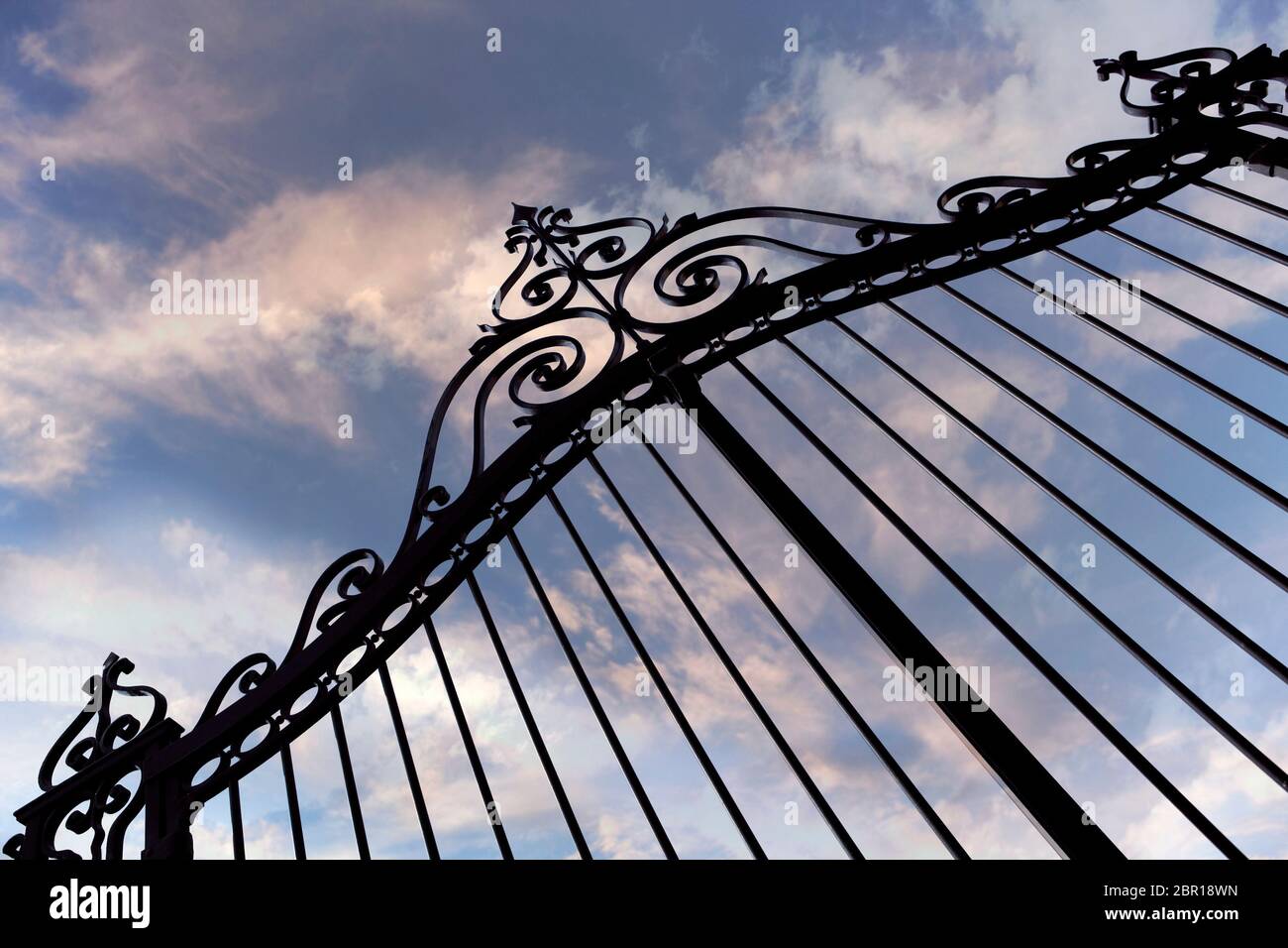 Closed metal gate and cloudy sky Stock Photo - Alamy