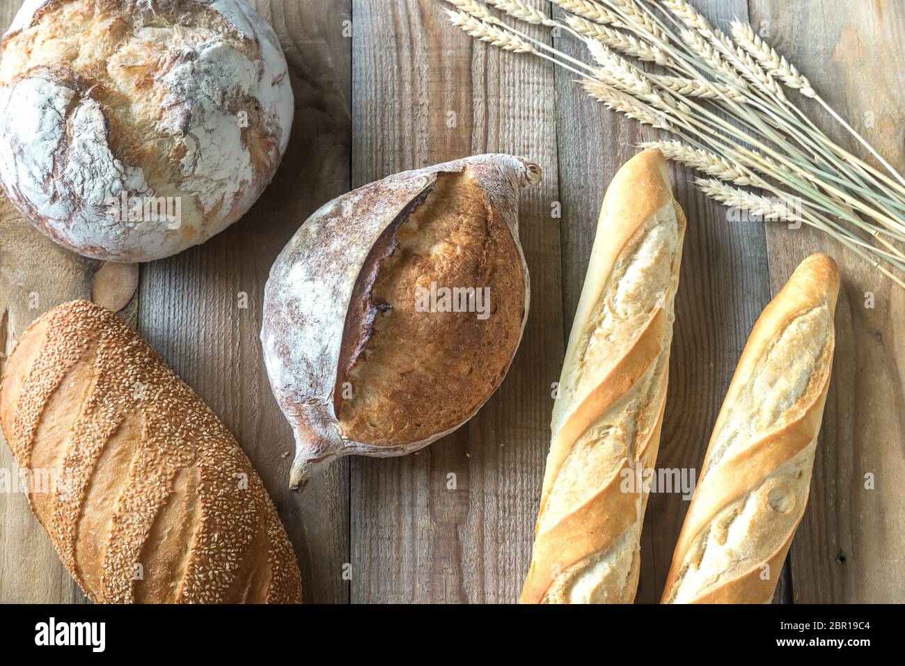Different kinds of bread on the wooden background Stock Photo - Alamy