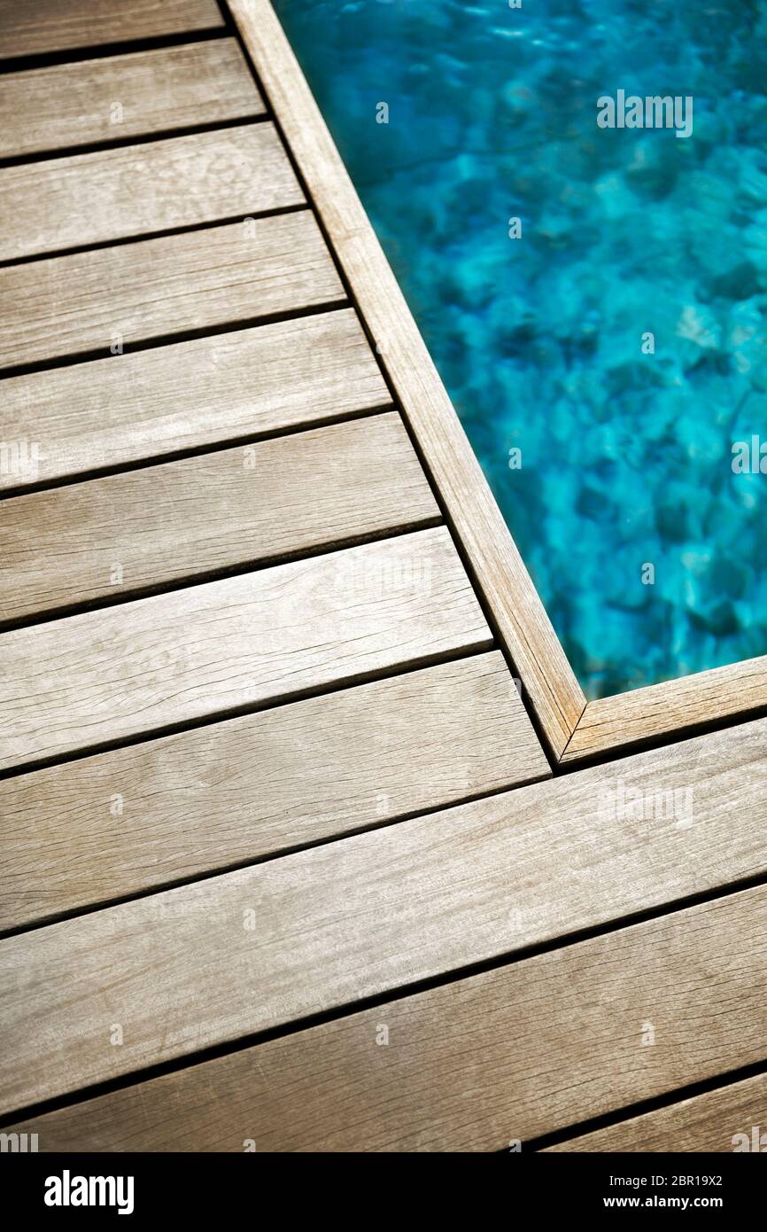 Teak terrace and details of a swimming pool Stock Photo - Alamy