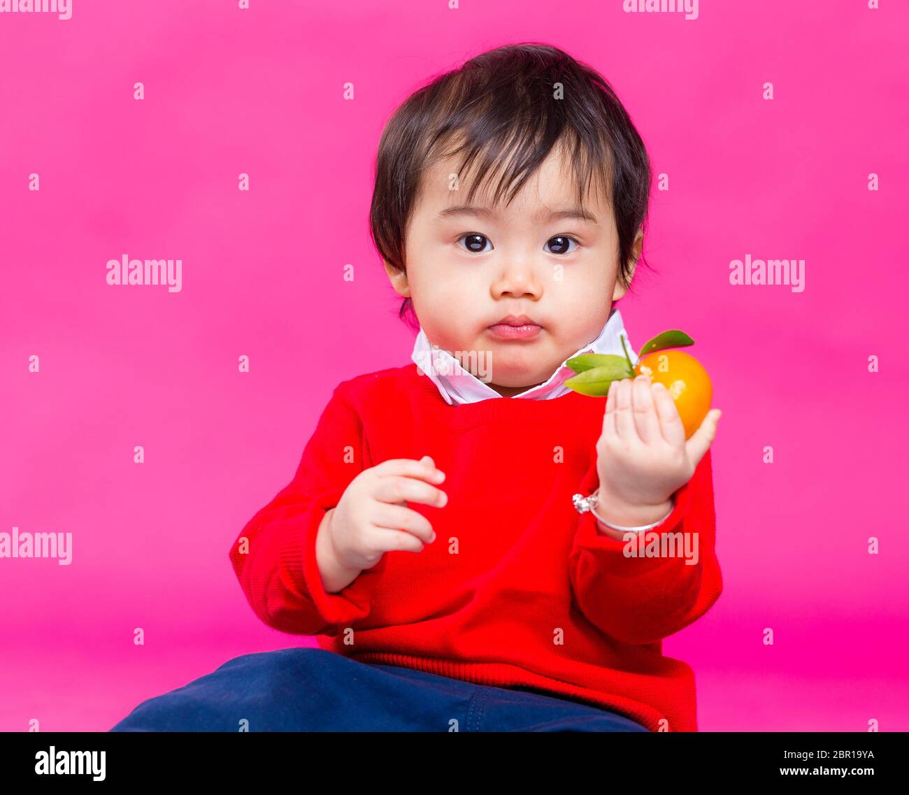 Boy holding mandarin fruit hi-res stock photography and images - Alamy