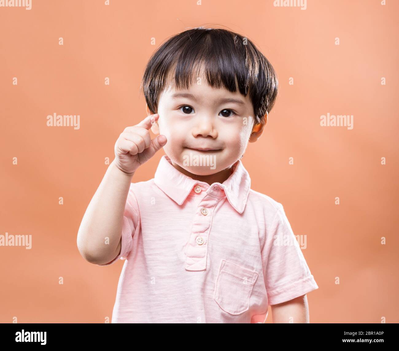 Asian baby boy finger pointing front Stock Photo - Alamy
