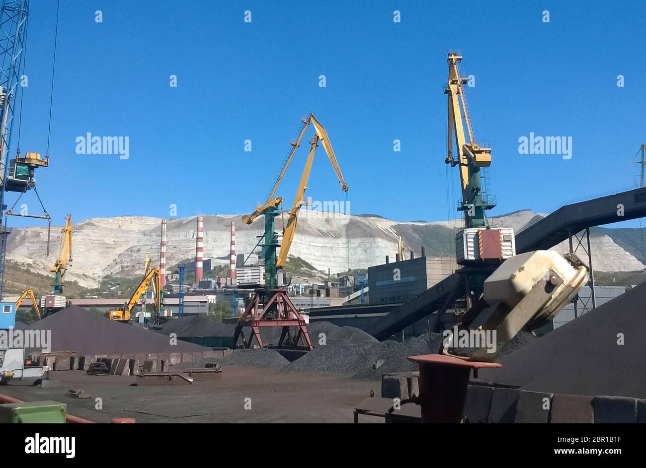 Cargo industrial port, port cranes. Loading of anthracite ...