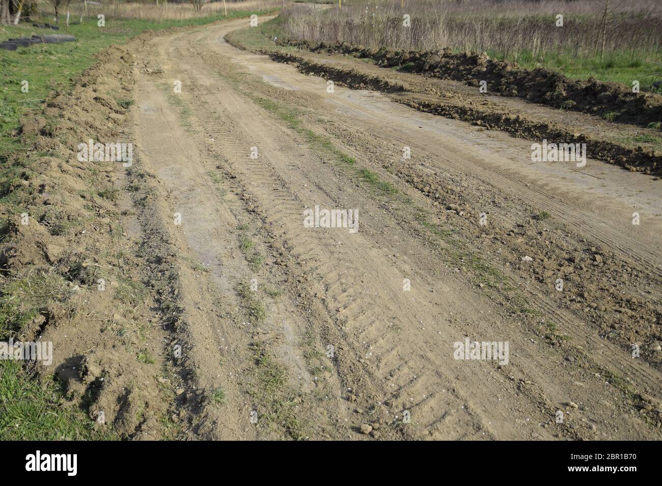 Dirt road leveled by a grader. Road in the village Stock Photo - Alamy