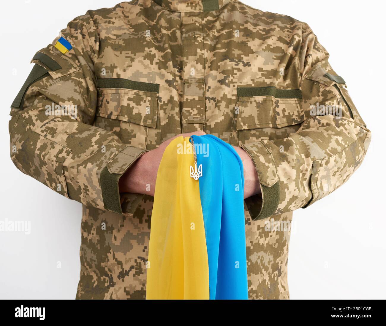 Ukrainian man warrior dressed in a military pixel uniform holds the ...