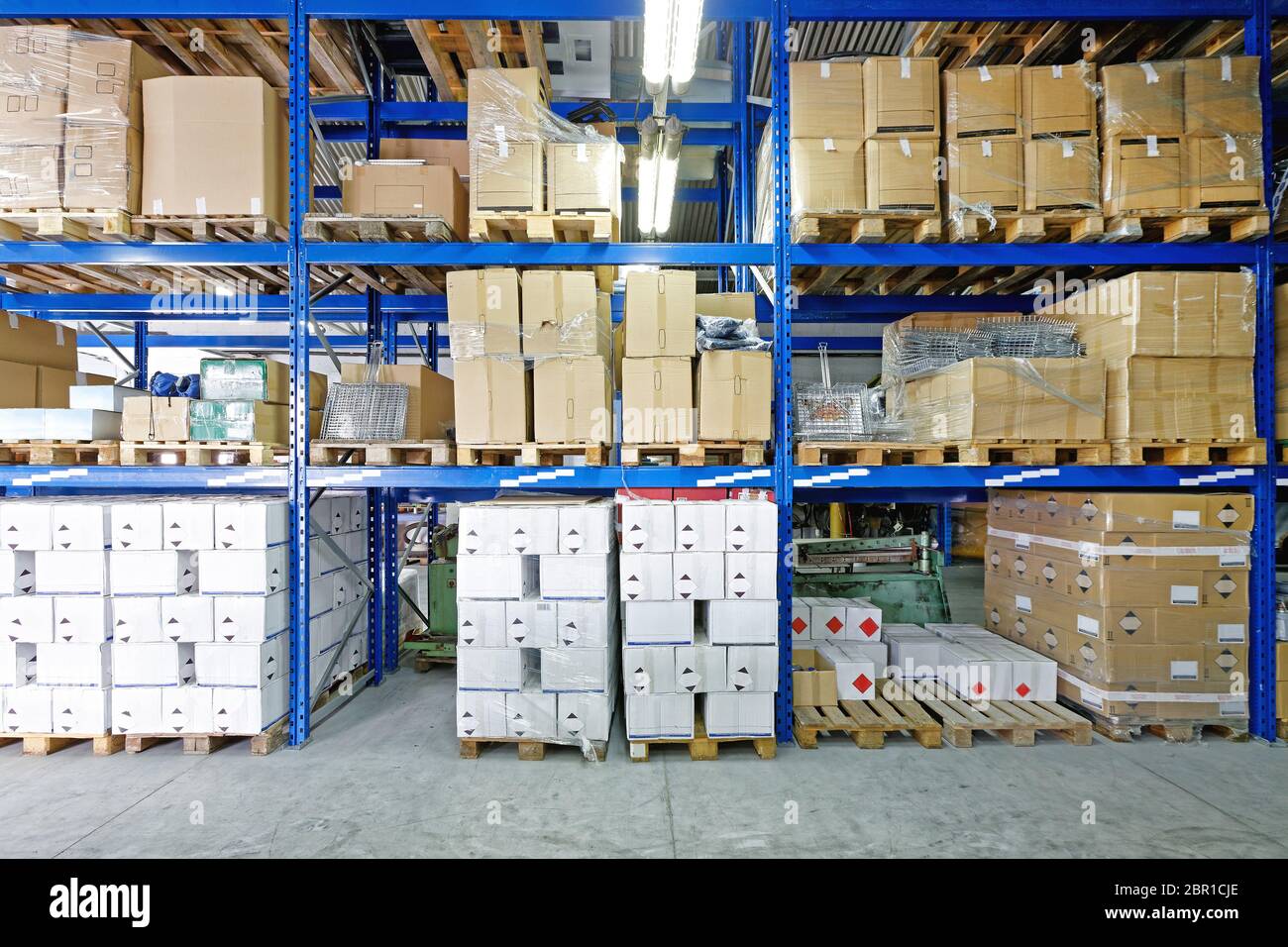 Boxes With Goods at Pallets in Distribution Warehouse Stock Photo - Alamy