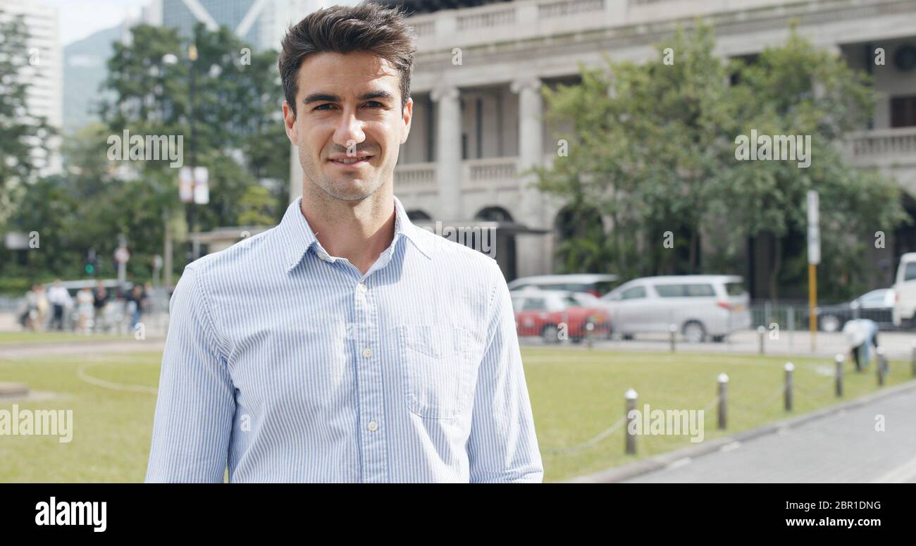 Confident man smile to camera Stock Photo - Alamy