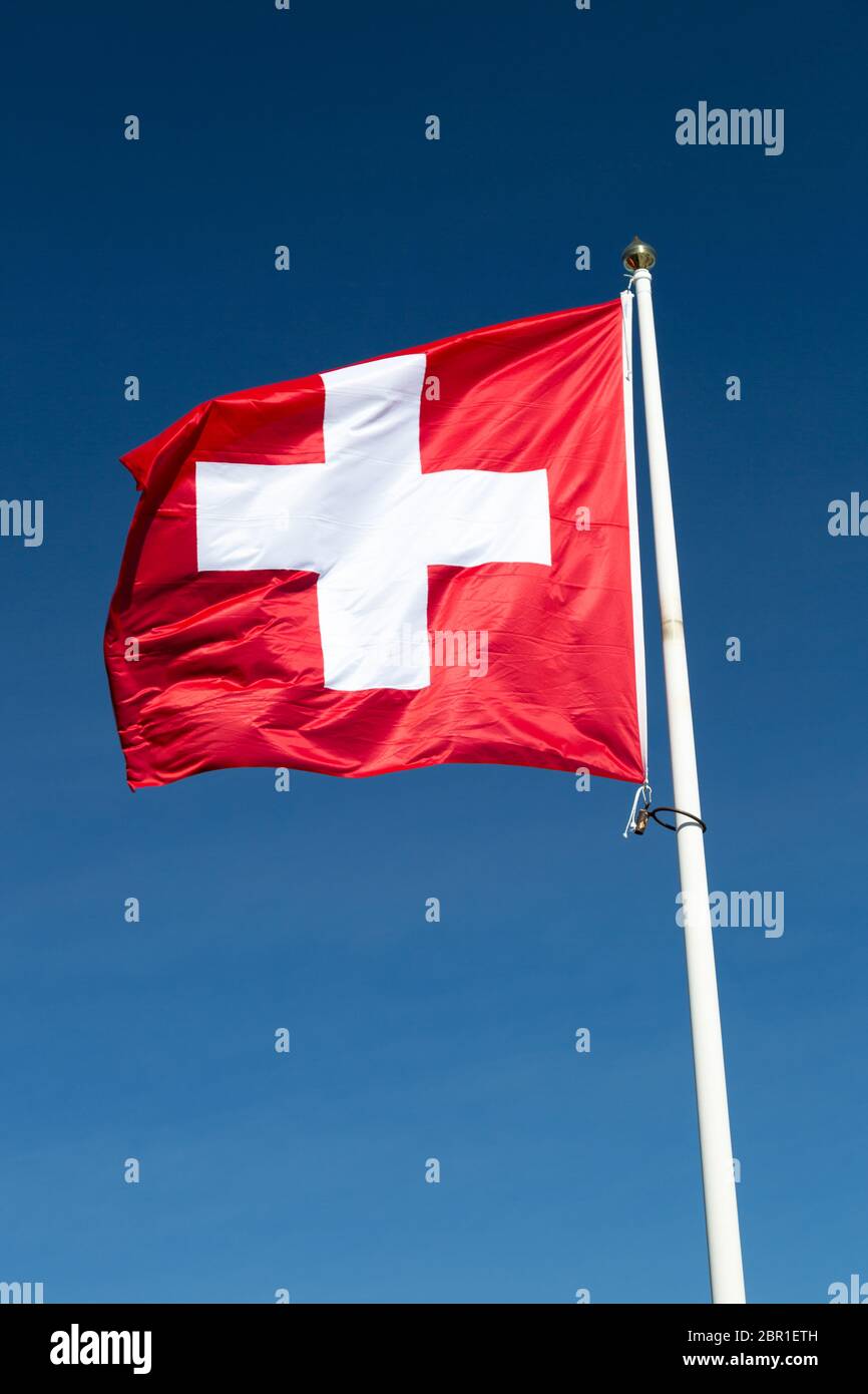 The Flag of Switzerland with a blue sky Stock Photo - Alamy