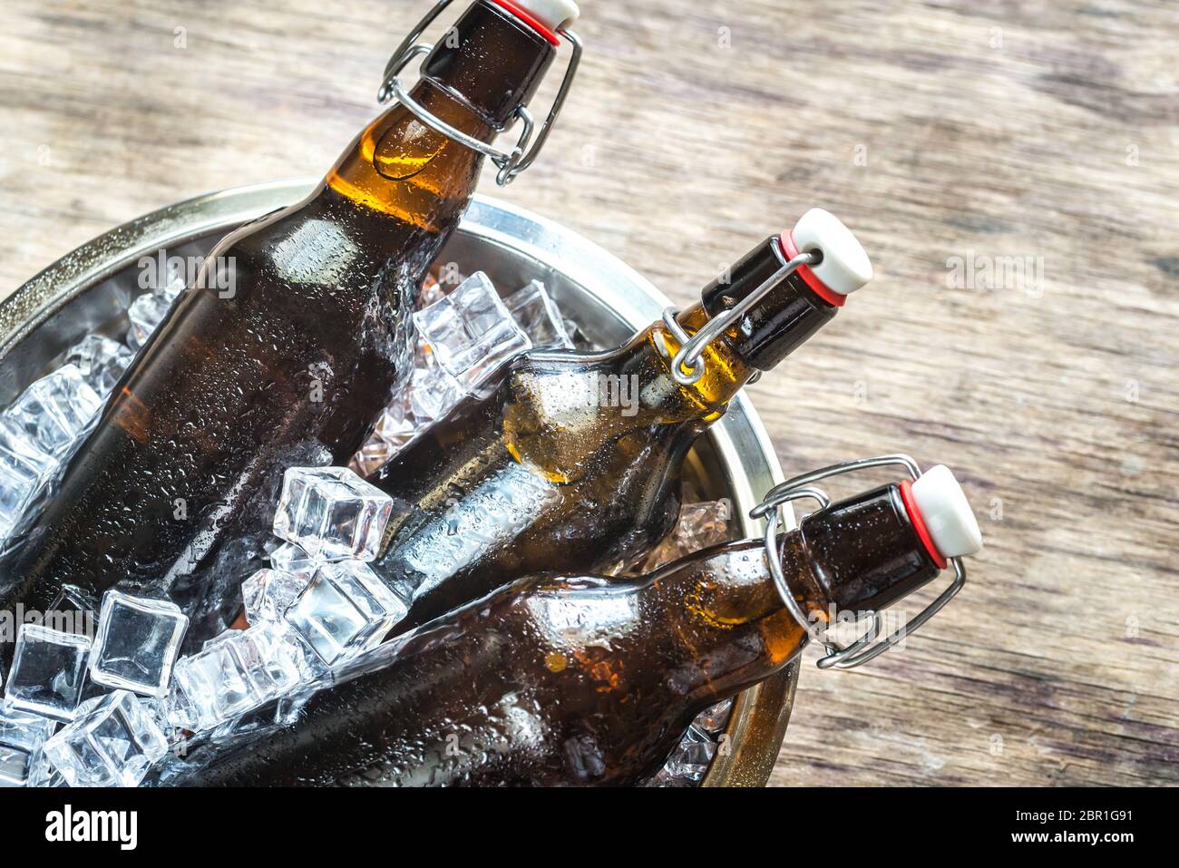 Bottles of beer in ice cubes Stock Photo - Alamy