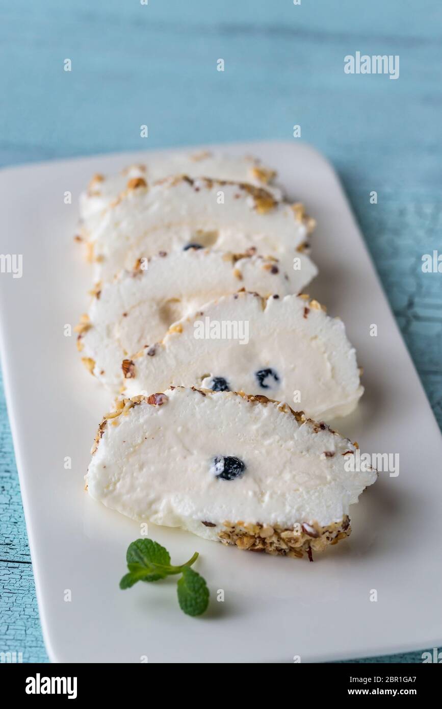 Sliced merengue roll with nuts Stock Photo - Alamy