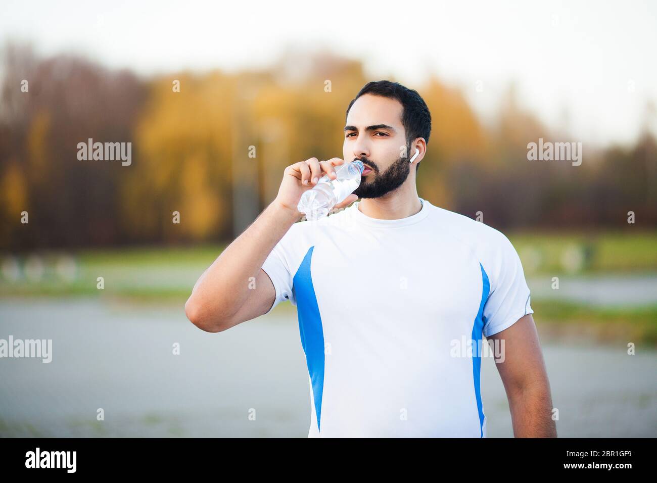 Fitness. Exhausted runner man resting on the park after workout Stock ...