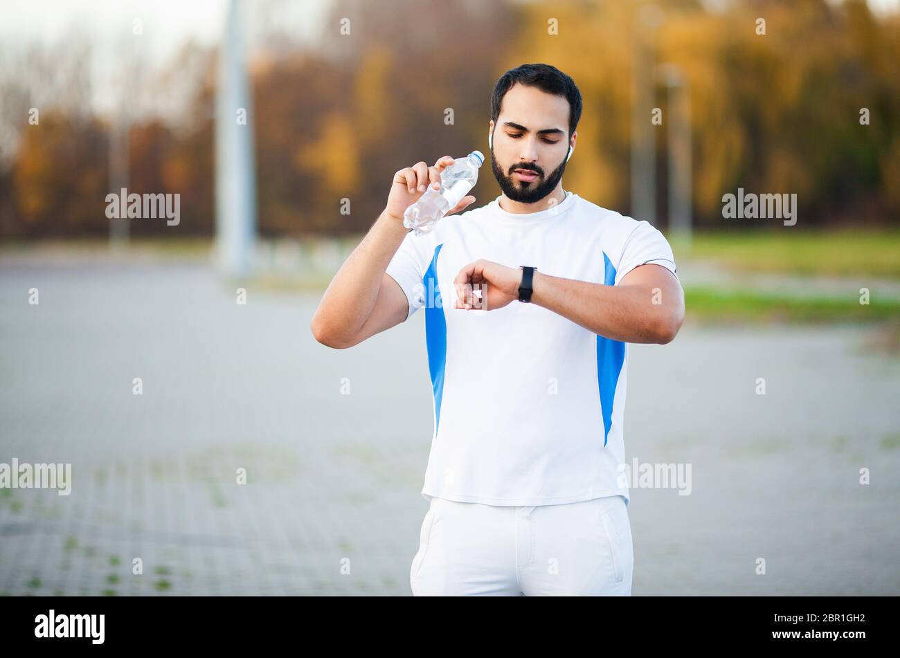 Fitness. Young sports man drinking water after workout Stock Photo - Alamy