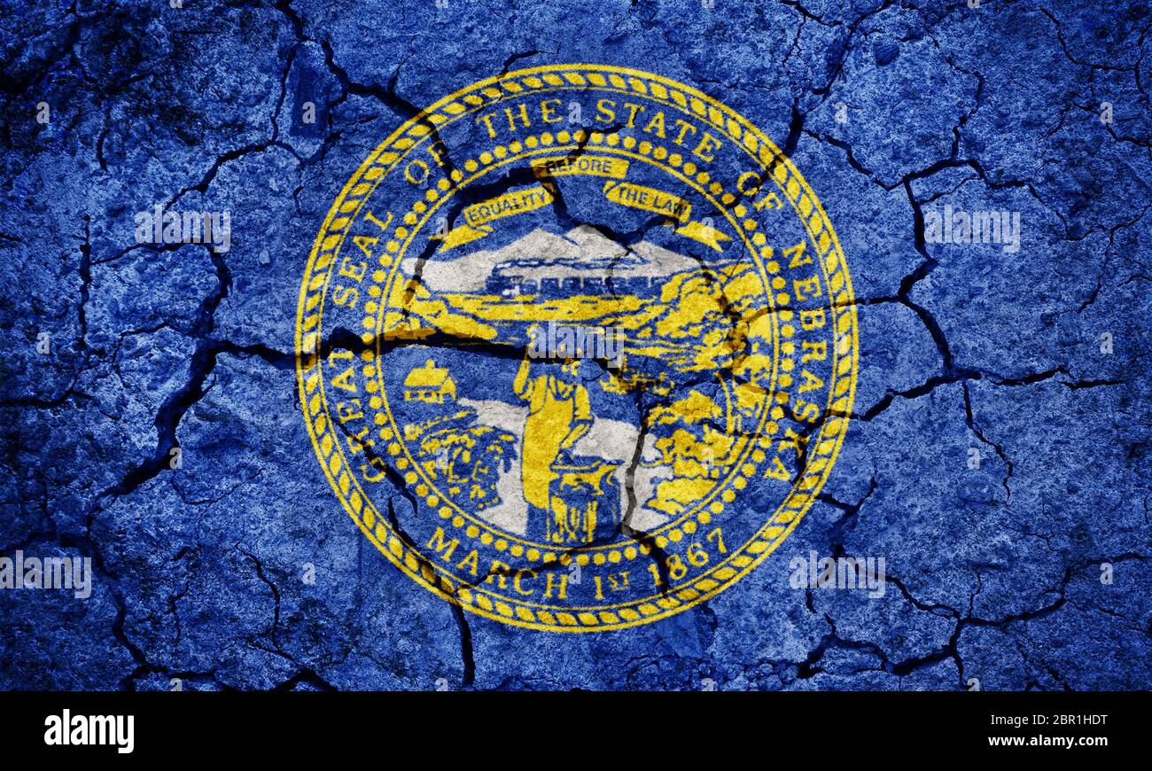 Flag of the state of Nebraska on dry earth ground texture background ...
