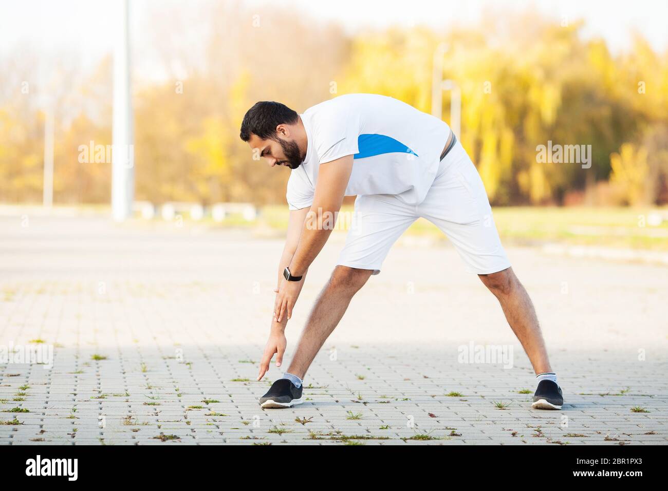 Fitness. Stretch man doing stretching exercise. Standing forward bend ...