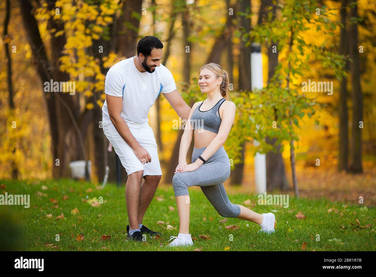 Fitness. Personal Trainer Takes Notes While Woman Exercising Outdoor ...