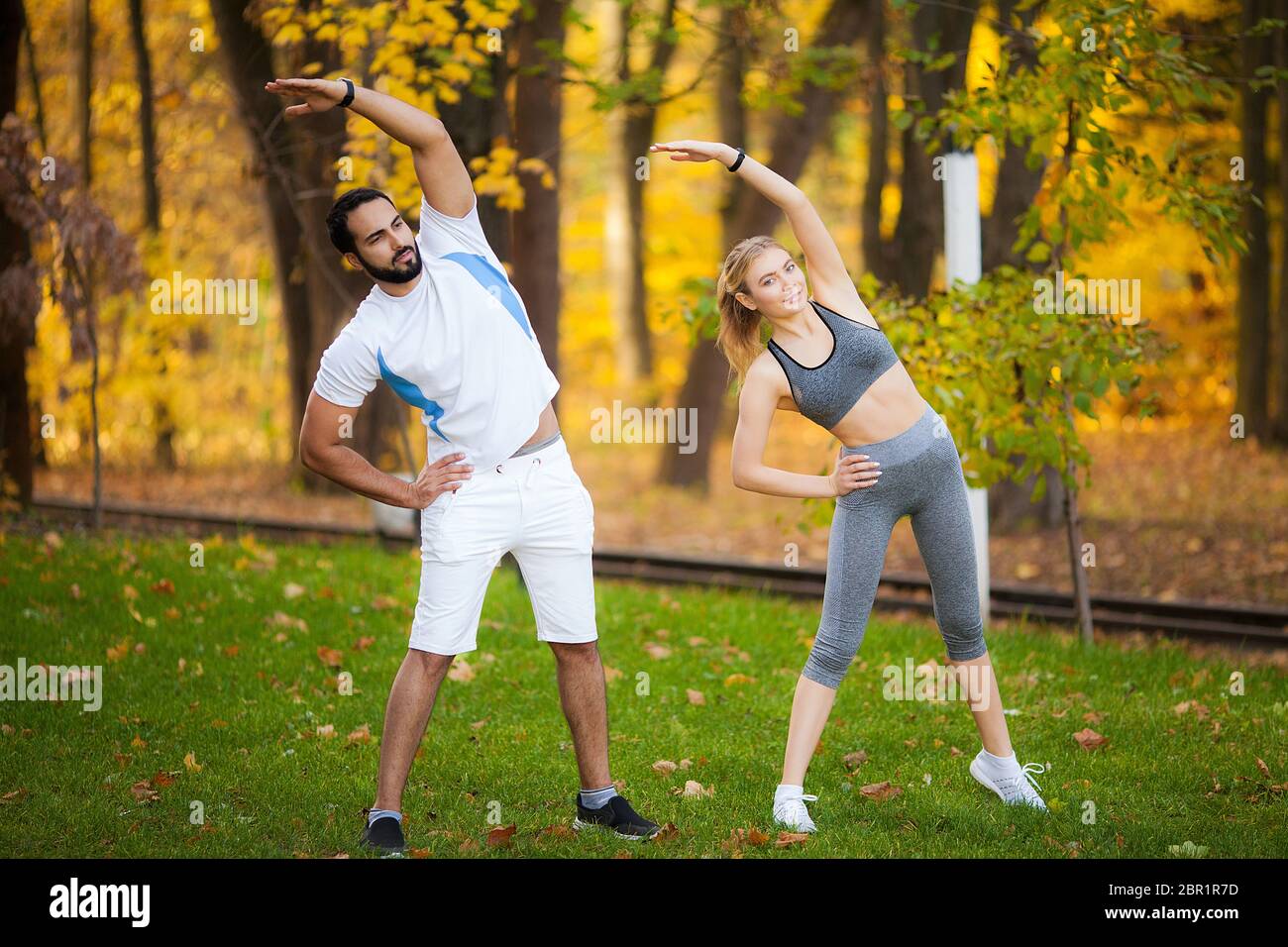 Fitness. Personal Trainer Takes Notes While Woman Exercising Outdoor ...