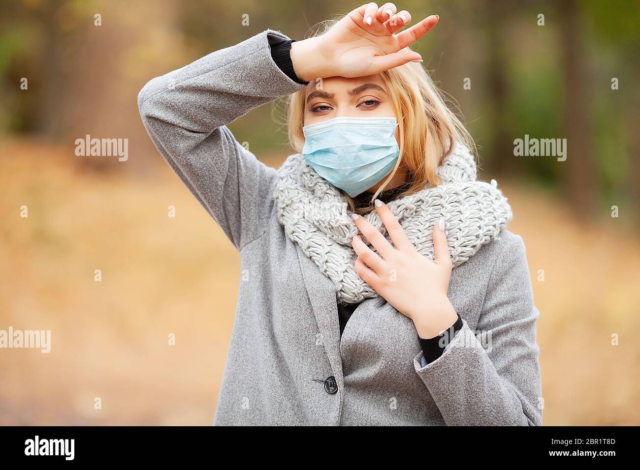 Cold and flu. Woman with a medical face mask at outdoor Stock Photo - Alamy