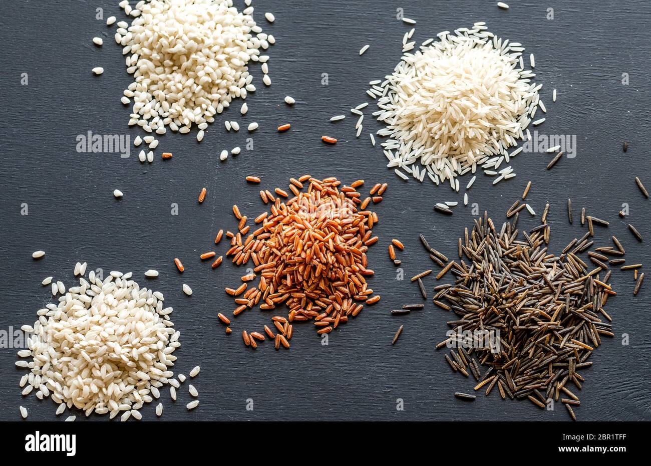 Different kinds of rice on the dark background Stock Photo - Alamy