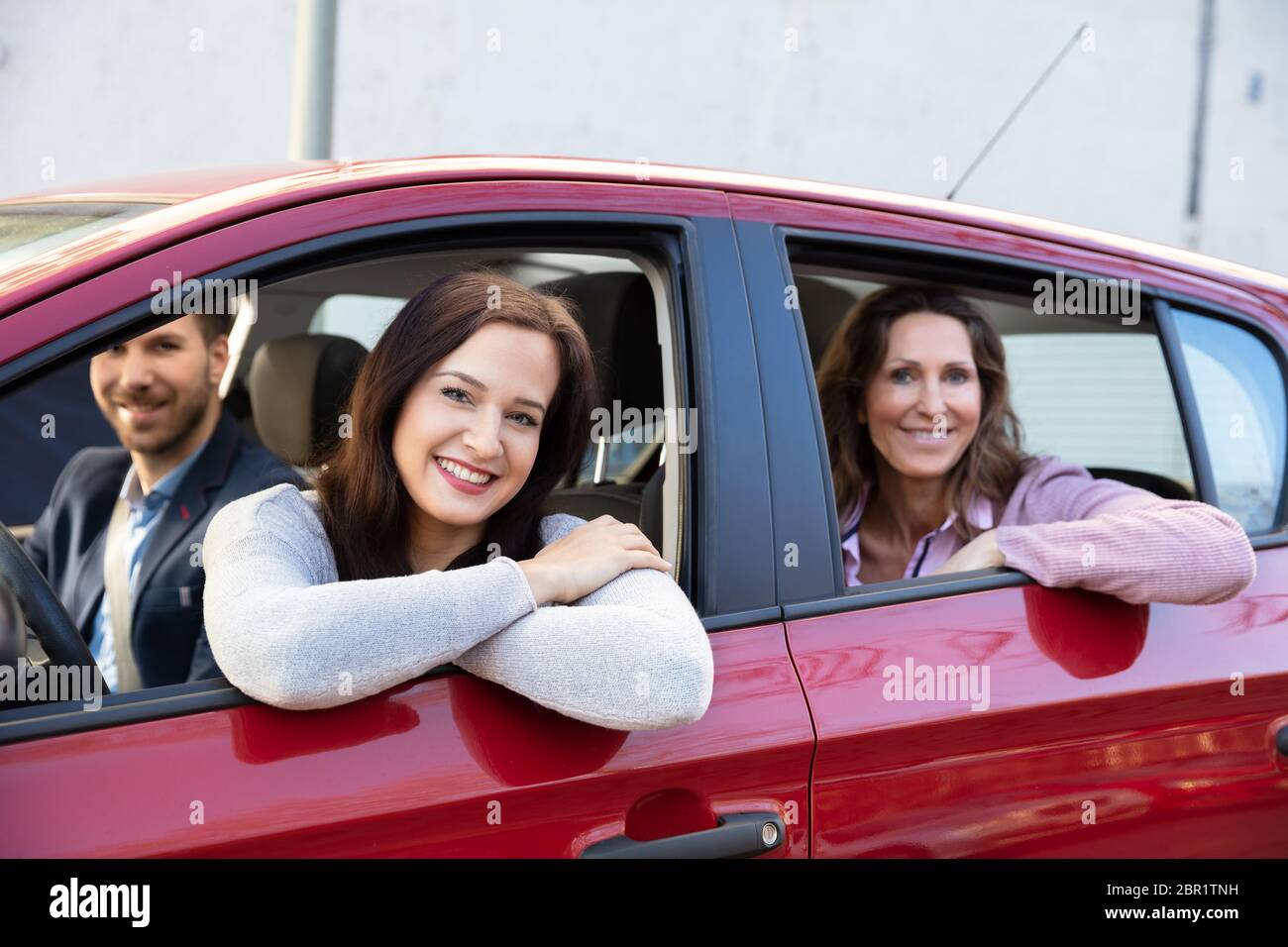 Smiling People Sitting In The Car Looking Out Windows Stock Photo - Alamy