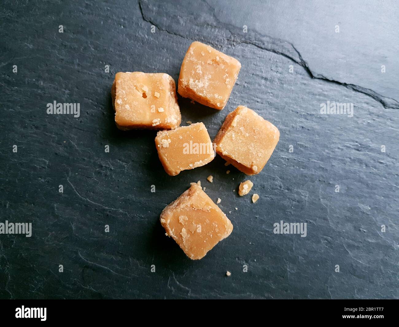 Home made fudge cubes on a natural slate worktop Stock Photo - Alamy