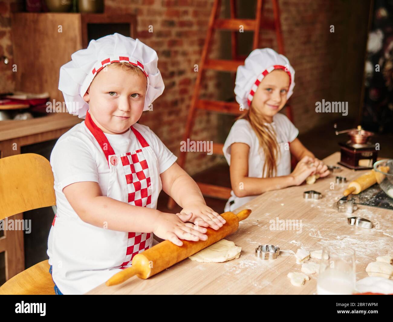 Little boy is cooking in a domestic kitchen. Happy family, happy kids ...