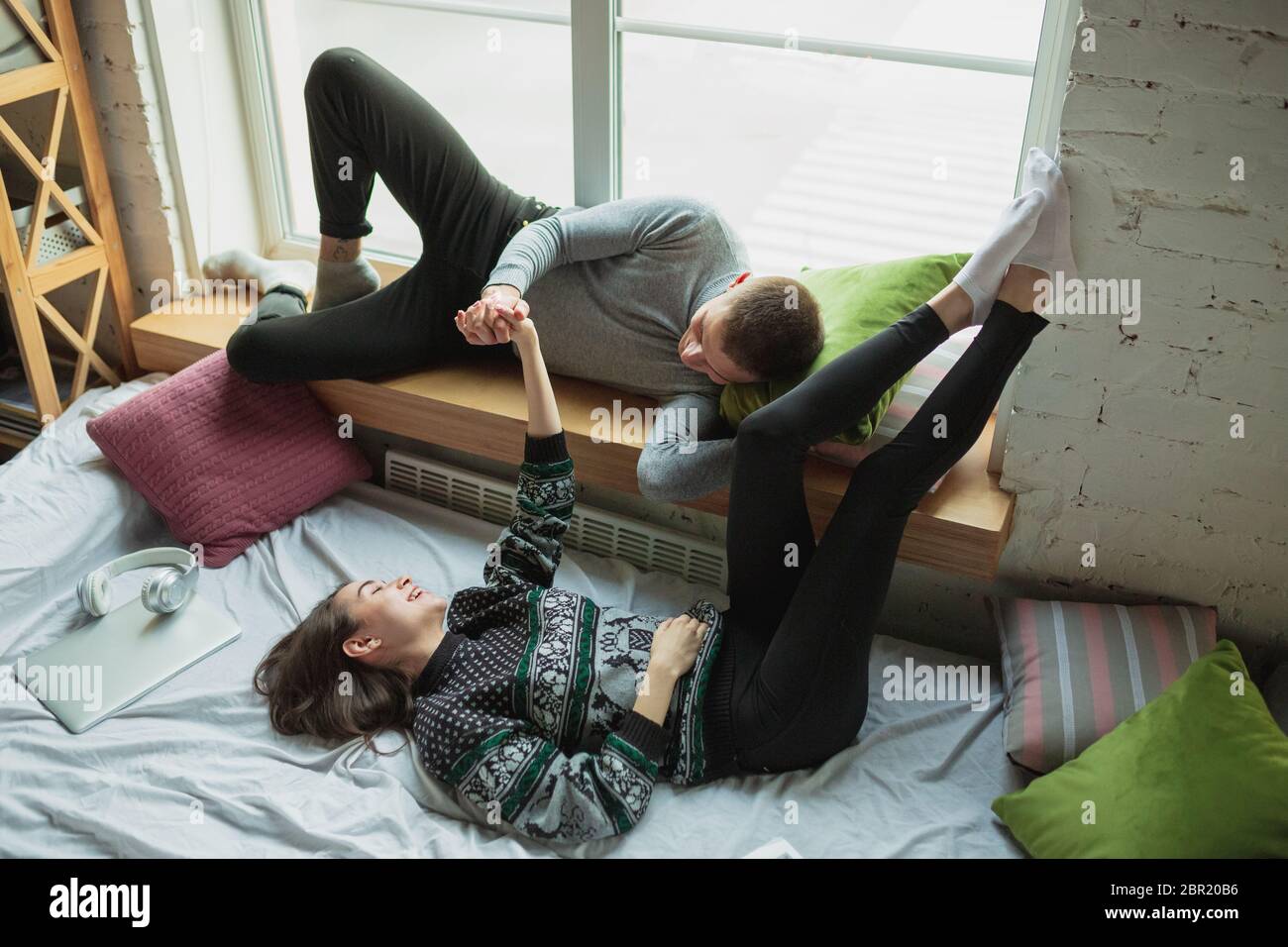 Lying down in bedroom, talking. Quarantine lockdown, stay home concept ...