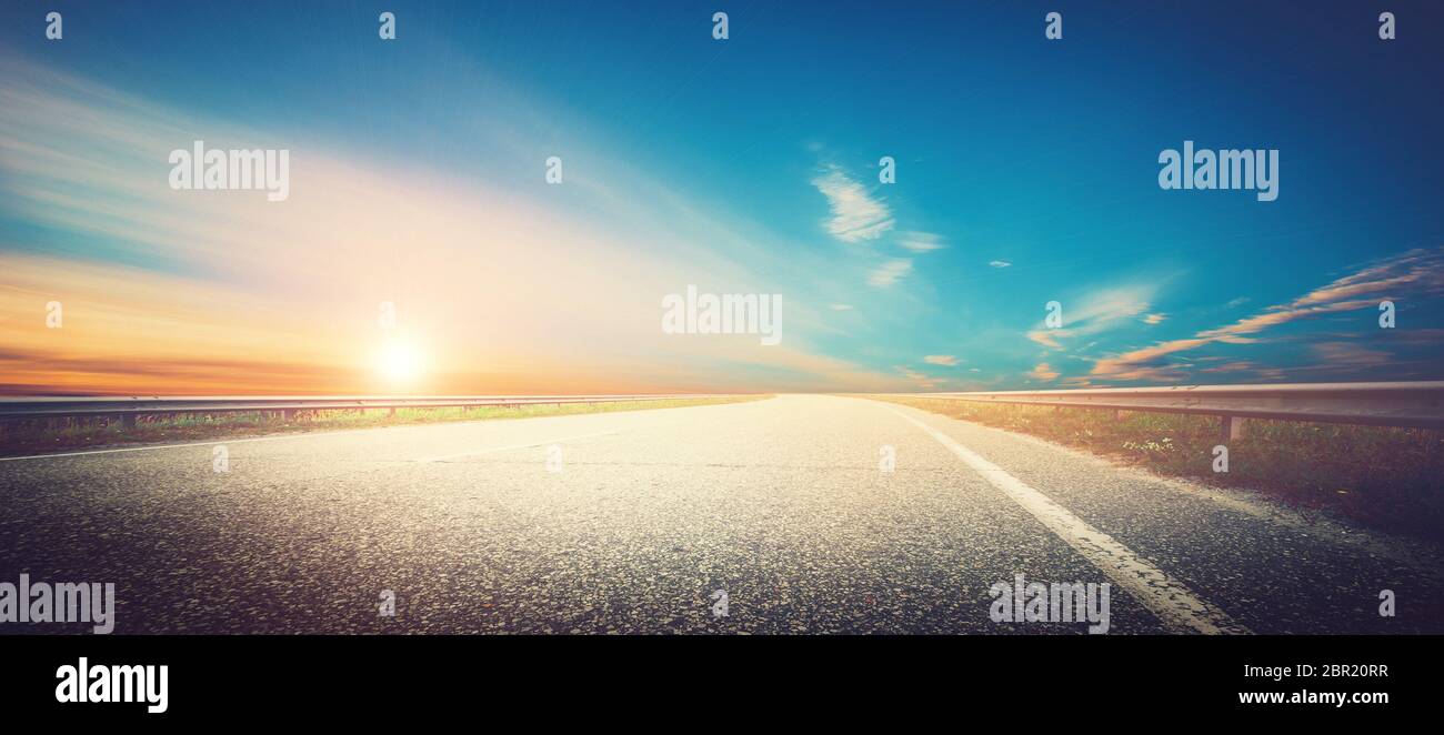 Panoramic road sunrise summer travel background Stock Photo - Alamy