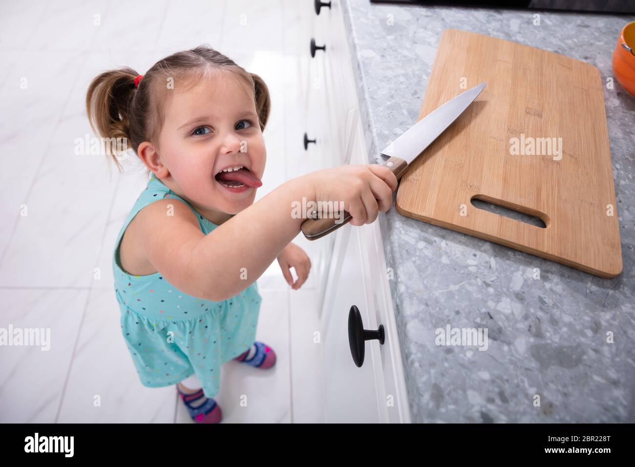 Happy Little Baby Girl Taking Kitchen Knife Stock Photo - Alamy