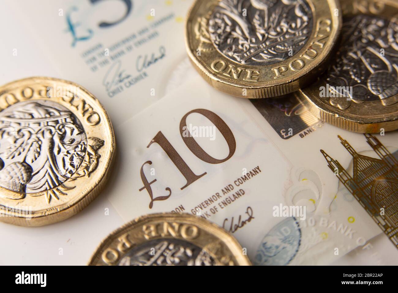 One pound coin with the face of Queen Elizabeth II and 5 and 10 pounds ...
