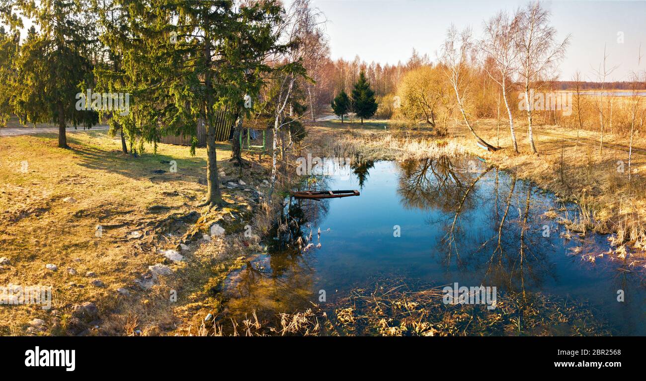 Spring aerial landscape. Panorama of lake in forest at morning time ...