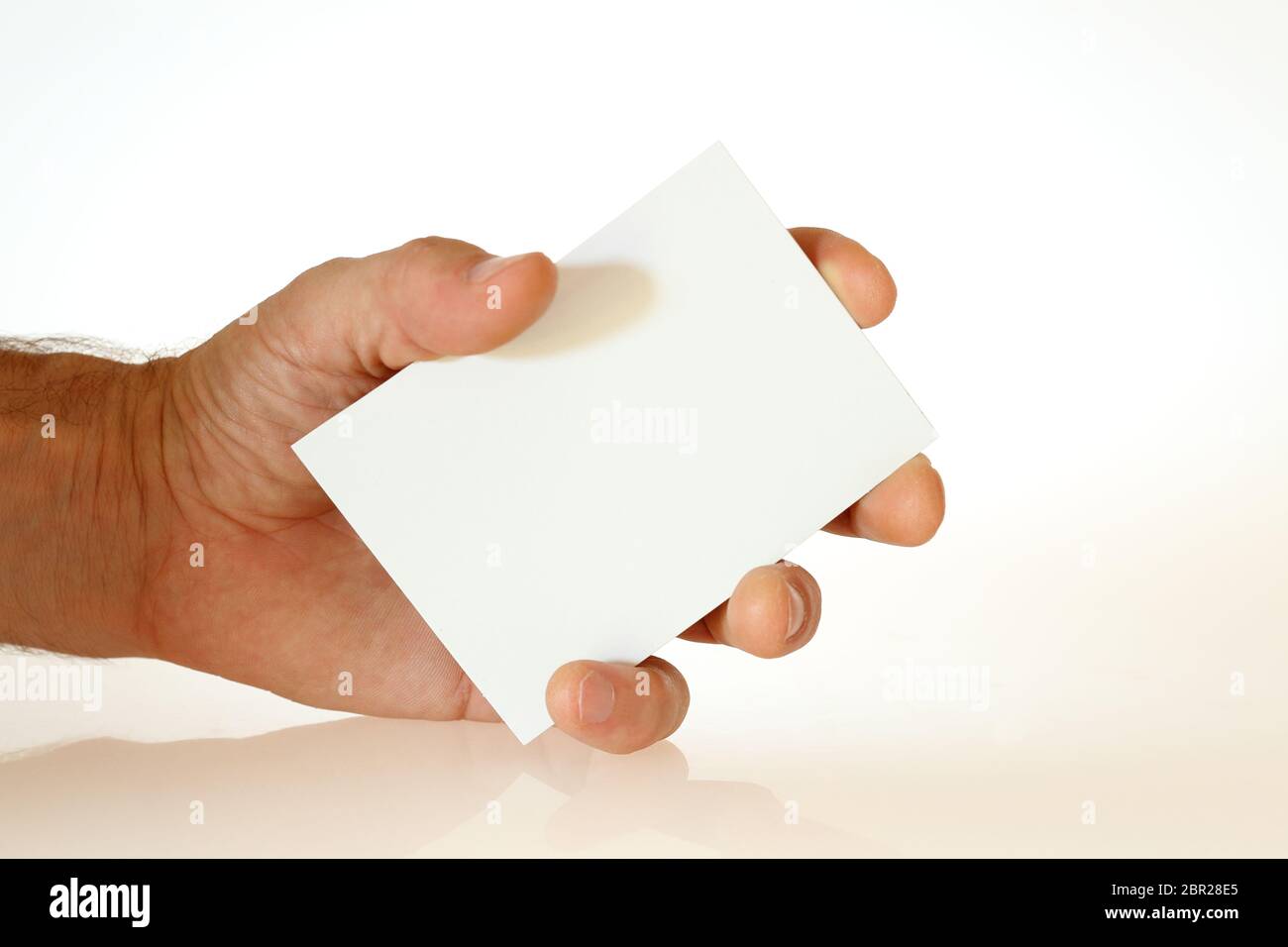 a hand is holding an empty white card Stock Photo - Alamy